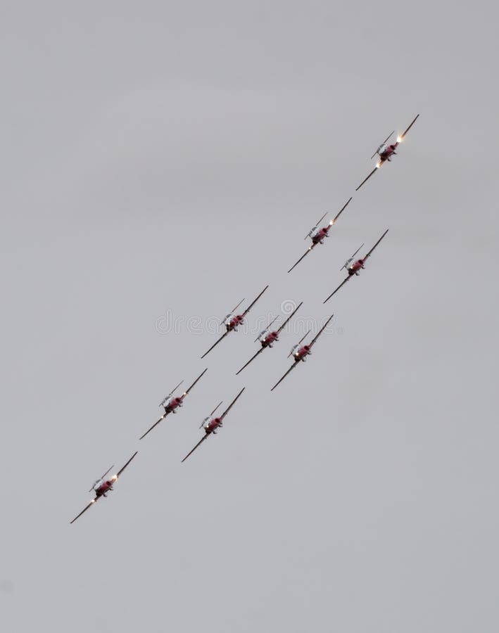 Nine Red and White Airplanes Flying in Formation with Navigation Lights ...