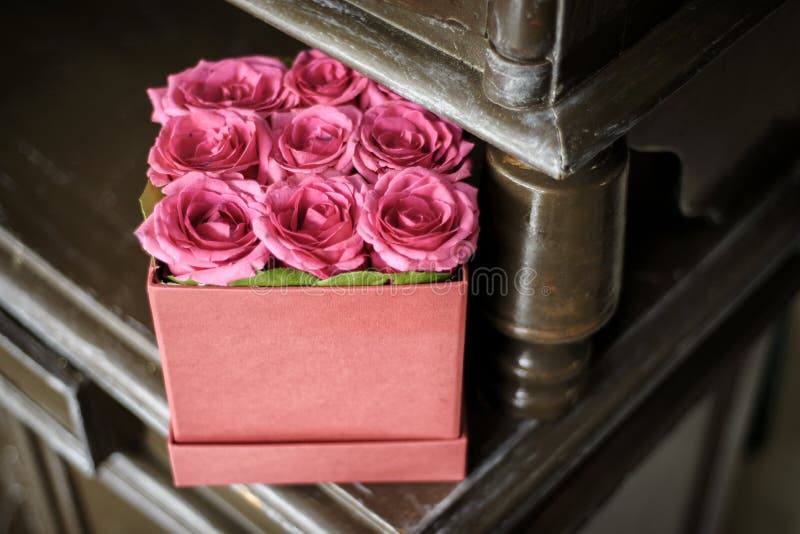 Nine Roses in a Box on the Chest of Drawers. Stock Image - Image of ...