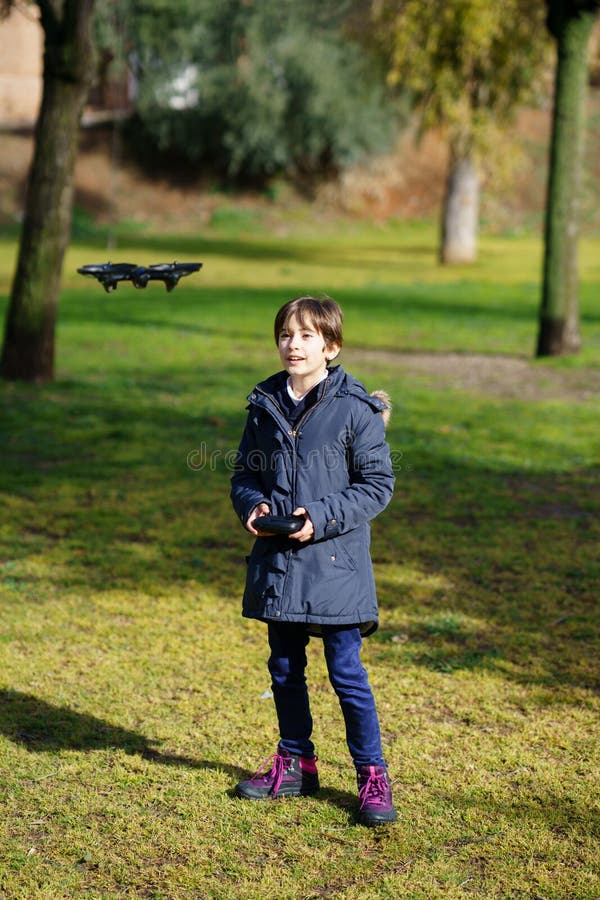 Nine-year-old Girl Operating Toy Drone Flying by Remote Control Stock ...