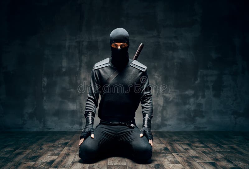 Ninja Kneeling Posing with a Sword Over Black Background Stock Image ...