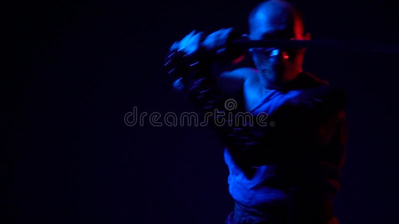 Ninja in a Mask and Kimono Pulls Out a Katana from Its Scabbard ...