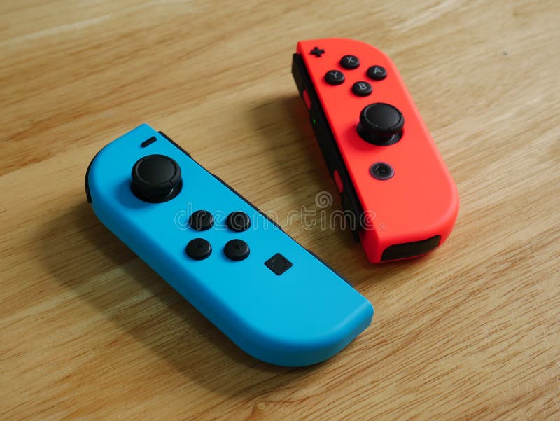 Nintendo Switch Controllers on Wooden Table. Editorial Photo - Image of ...