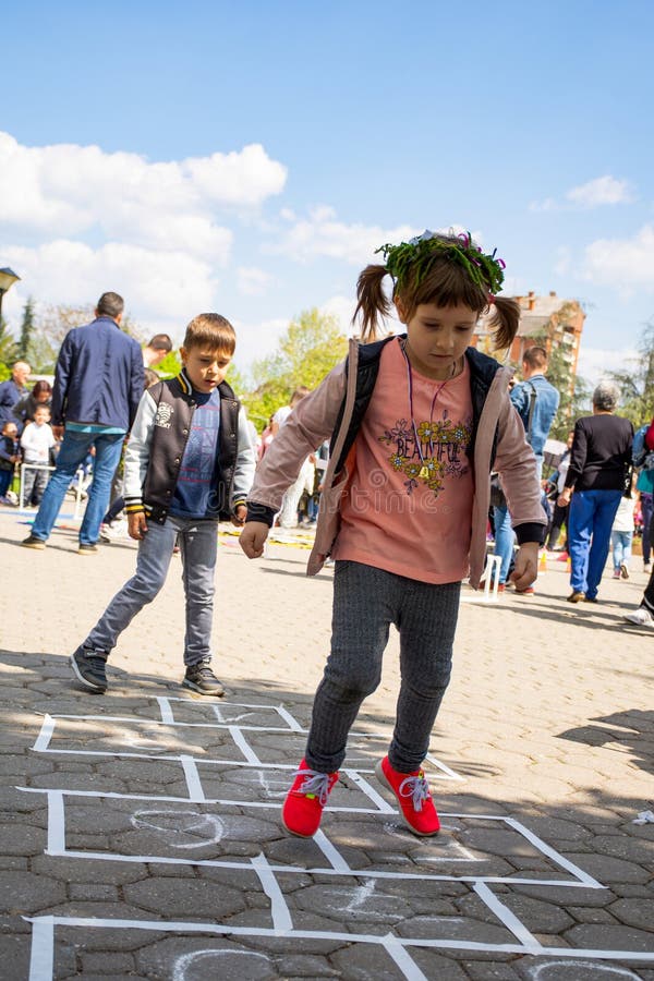 Leap into Learning: Little Girl Jumping on Chalk Marked Squares and ...