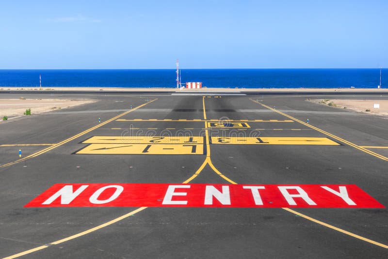 No Entry Sign at the Runway of the Airport with Ocean in Background ...