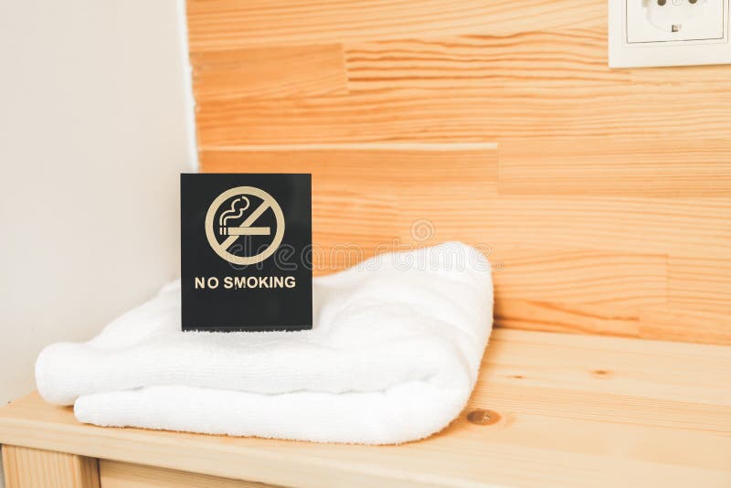 No Smoking Sign on the Bedside Table. Hotel Towels Stock Photo - Image ...