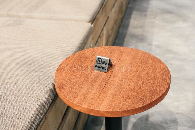 No Smoking Sign on Wood Table with Sunlight in Cafe Stock Image - Image ...