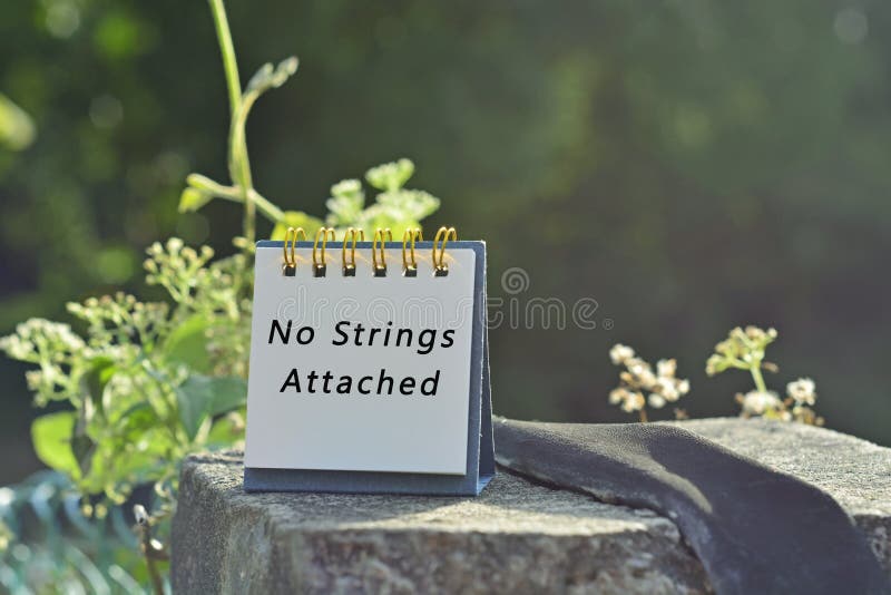 No Strings Attached Text Written on White Note with Green Blurred ...