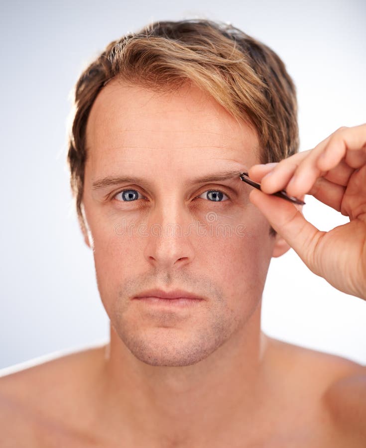 Nobody Likes Bushy Eyebrows. Cropped Studio Shot of a Man Concentrating ... Nobody Likes Bushy Eyebrows. Cropped Studio Shot of a Man Concentrating ...