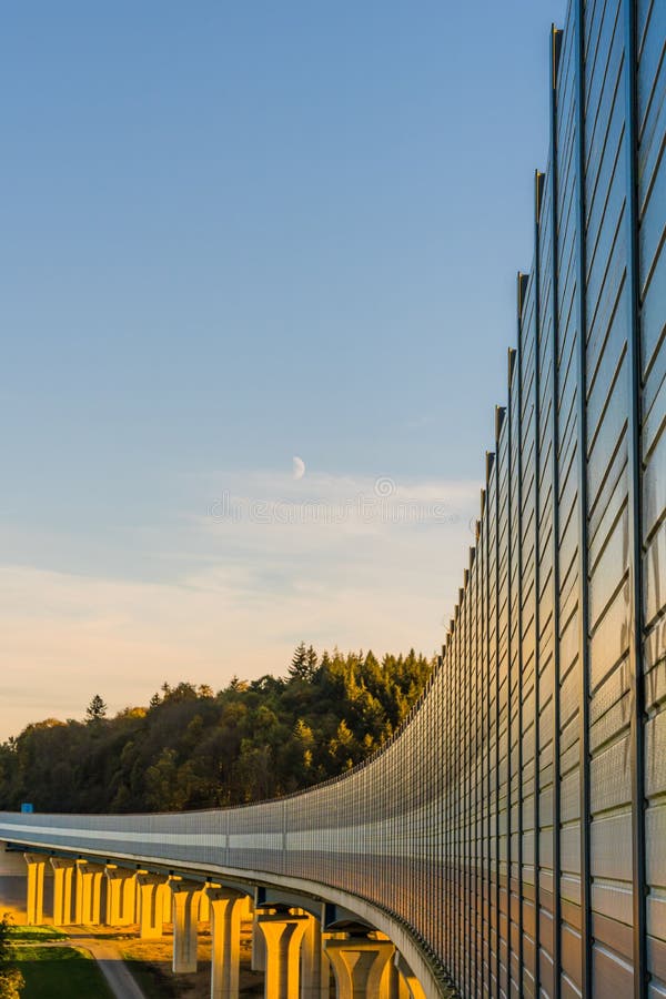 Noise Barrier on A45 Bridge Illuminated by Sun Rays, Surrounded by ...