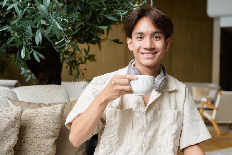 Non Binary Asian Student Man Sitting in Modern Cafe Drinking Coffee ...