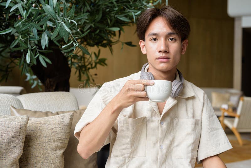 Non Binary Asian Student Man Sitting in Modern Cafe Drinking Coffee ...