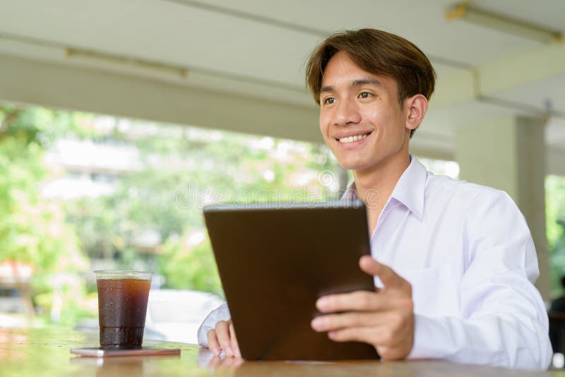 Non Binary University Student Sitting in College Campus Using Tablet ...