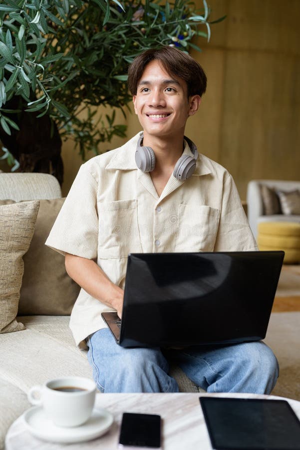 Non Binary Asian Student Man Sitting in Modern Coffee Shop Using Laptop ...