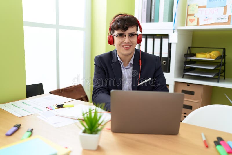 Non Binary Man Business Worker Using Laptop and Headphones Working at ...