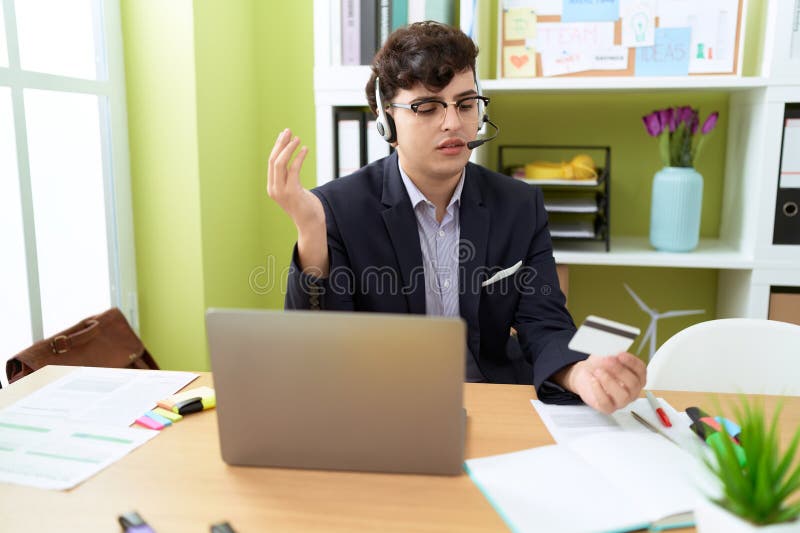 Non Binary Man Call Center Agent Using Computer and Credit Card Working ...