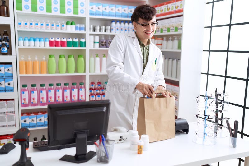 Non Binary Man Pharmacist Putting Products on Shopping Bag at Pharmacy ...