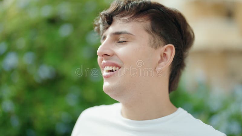 Non Binary Man Smiling Confident Looking To the Side at Park Stock ...