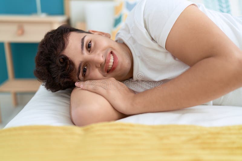 Non Binary Man Smiling Confident Lying on Bed at Bedroom Stock Photo ...