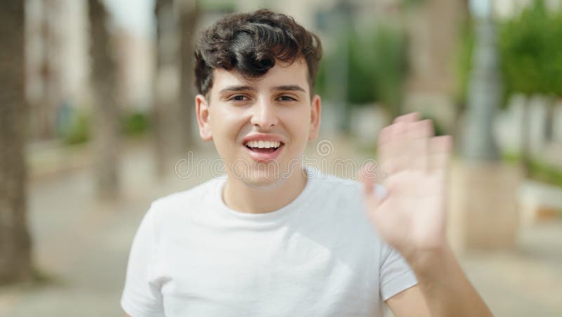 Non Binary Man Smiling Confident Saying Hello with Hand at Park Stock ...