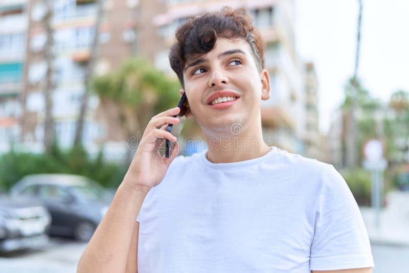Non Binary Man Smiling Confident Talking on Smartphone at Street Stock ...