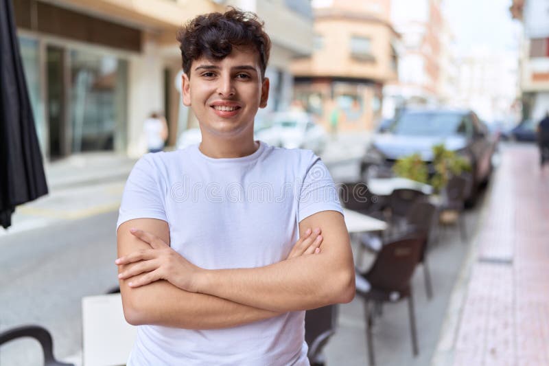Non Binary Man Standing with Arms Crossed Gesture at Coffee Shop ...