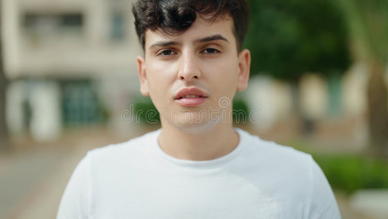 Non Binary Man Standing with Serious Expression at Park Stock Photo ...