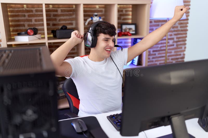 Non Binary Man Streamer Playing Video Game with Winner Expression at ...