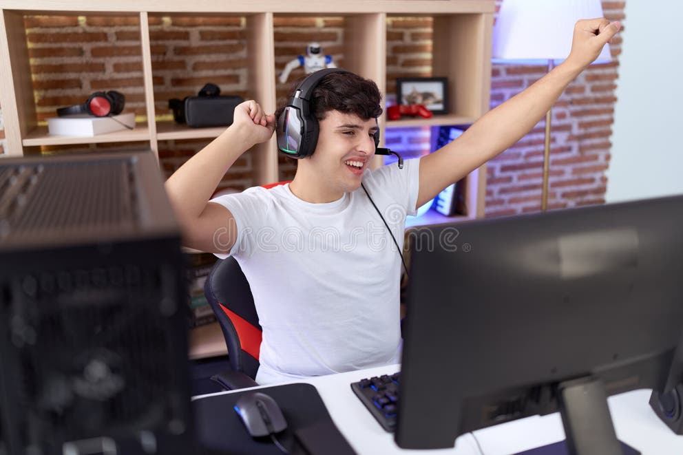 Non Binary Man Streamer Playing Video Game with Winner Expression at ...