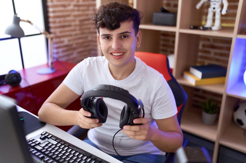 Non Binary Man Streamer Sitting on Table Holding Headphones at Gaming ...
