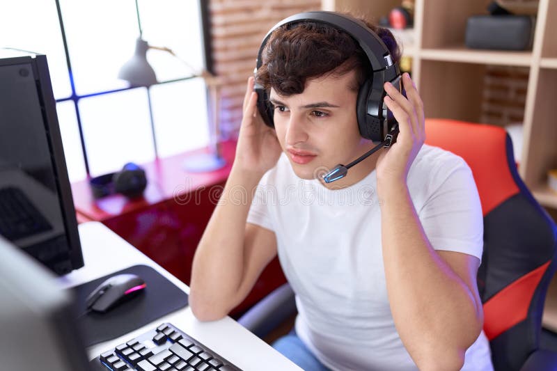 Non Binary Man Streamer Sitting on Table with Relaxed Expression at ...