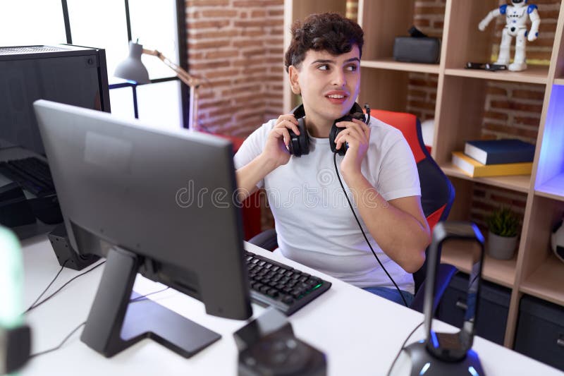 Non Binary Man Streamer Smiling Confident Sitting on Table at Gaming ...