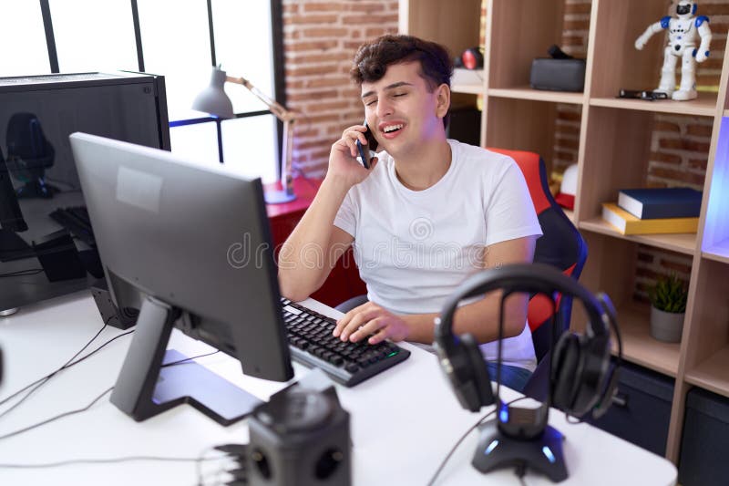 Non Binary Man Streamer Talking on Smartphone Using Computer at Gaming ...