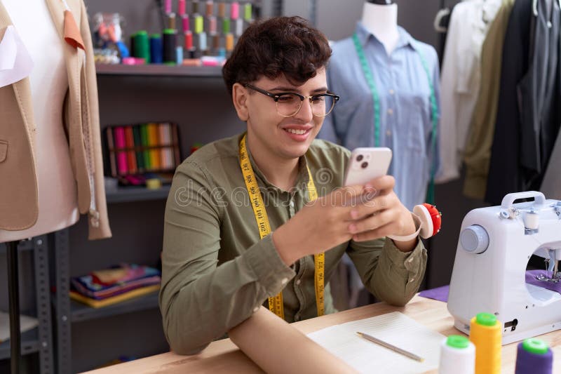 Non Binary Man Tailor Smiling Confident Using Smartphone at Atelier ... Non Binary Man Tailor Smiling Confident Using Smartphone at Atelier ...