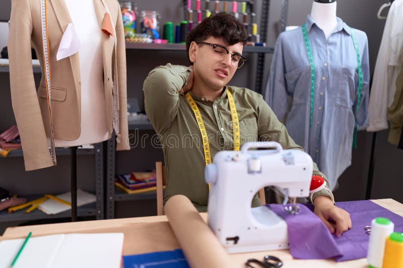 Non Binary Man Tailor Stressed Using Sewing Machine at Atelier Stock ... Non Binary Man Tailor Stressed Using Sewing Machine at Atelier Stock ...