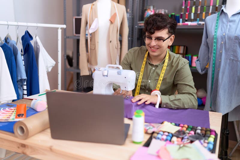 Non Binary Man Tailor Using Sewing Machine and Laptop at Atelier Stock ...