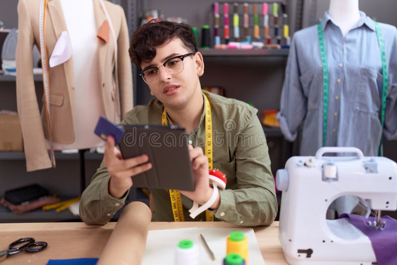 Non Binary Man Tailor Using Touchpad and Credit Card at Atelier Stock ...