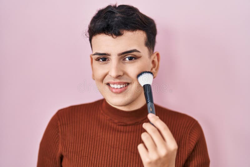 Non Binary Person Applying Make Up Looking Positive and Happy Standing ...
