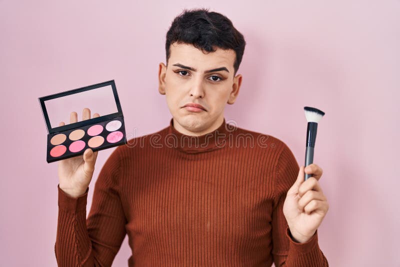 Non Binary Person Holding Makeup Brush and Blush Depressed and Worry ... Non Binary Person Holding Makeup Brush and Blush Depressed and Worry ...