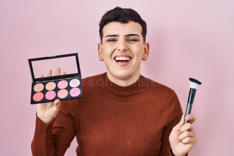 Non Binary Person Holding Makeup Brush and Blush Smiling and Laughing ... Non Binary Person Holding Makeup Brush and Blush Smiling and Laughing ...