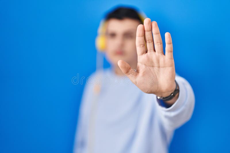 Non Binary Person Listening To Music Using Headphones Doing Stop Sing ...