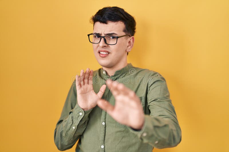 Non Binary Person Standing Over Yellow Background Afraid and Terrified ...