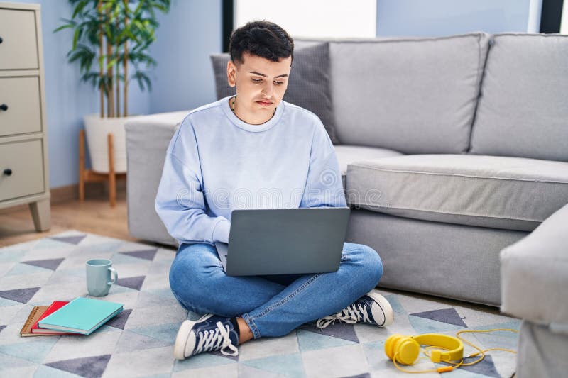 Non Binary Person Studying Using Computer Laptop Sitting on the Floor ...