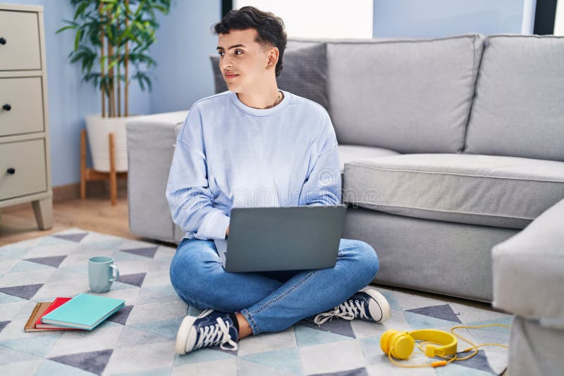 Non Binary Person Studying Using Computer Laptop Sitting on the Floor ...