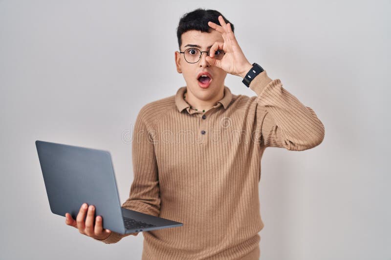 Non Binary Person Using Computer Laptop Doing Ok Gesture Shocked with ...