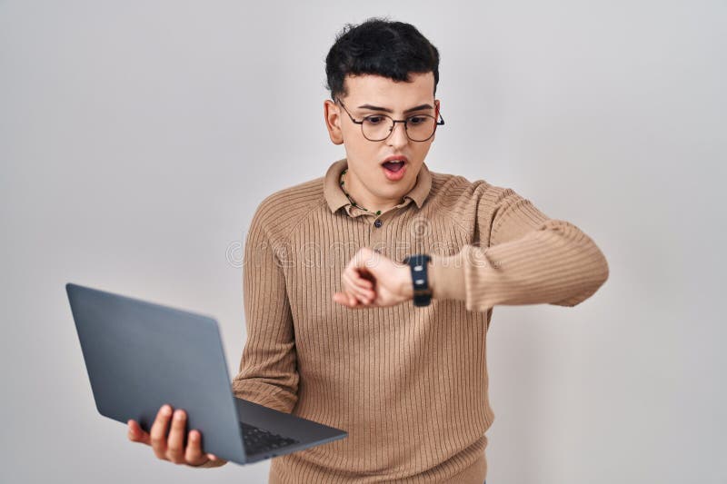 Non Binary Person Using Computer Laptop Looking at the Watch Time ...