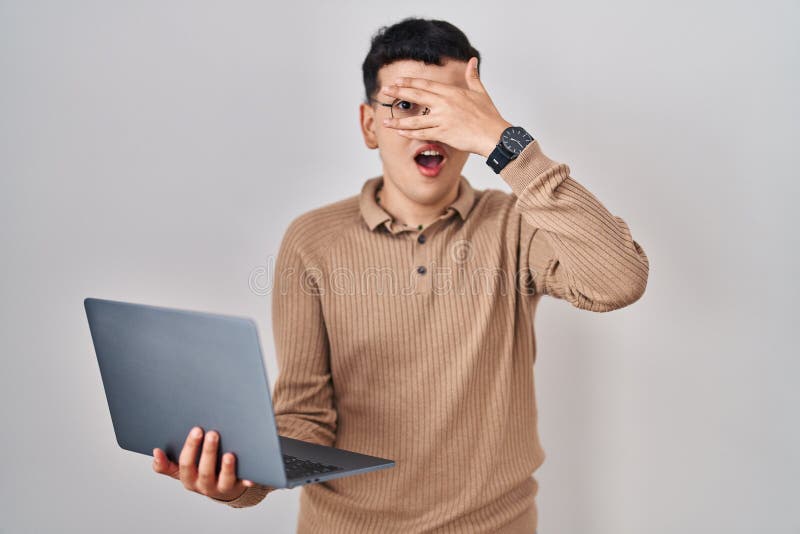 Non Binary Person Using Computer Laptop Peeking in Shock Covering Face ...