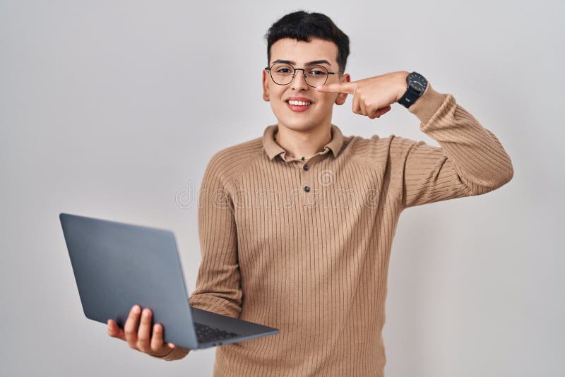 Non Binary Person Using Computer Laptop Pointing with Hand Finger To ... Non Binary Person Using Computer Laptop Pointing with Hand Finger To ...