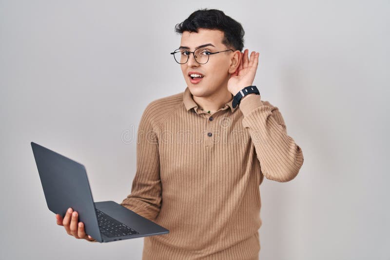 Non Binary Person Using Computer Laptop Smiling with Hand Over Ear ... Non Binary Person Using Computer Laptop Smiling with Hand Over Ear ...