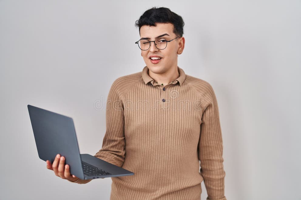 Non Binary Person Using Computer Laptop Winking Looking at the Camera ...