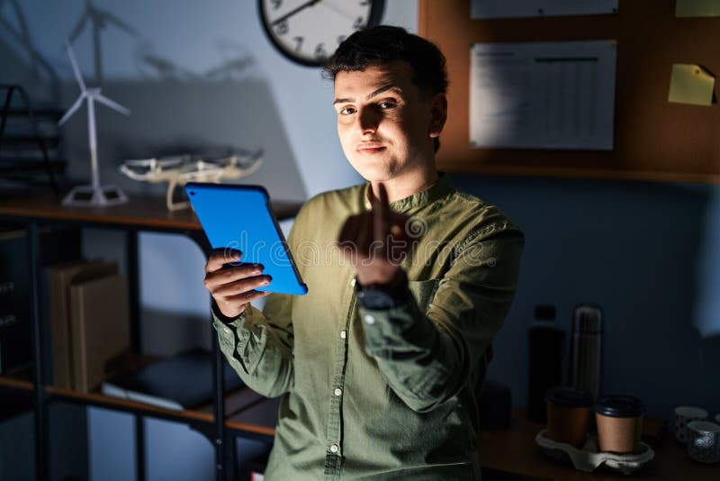 Non Binary Person Using Touchpad Device at Night Beckoning Come Here ...